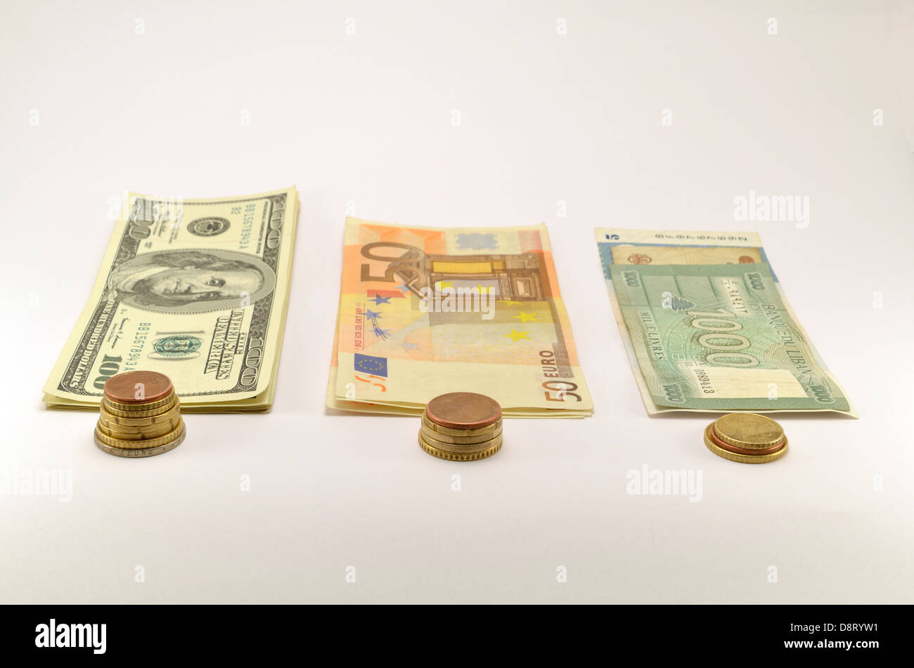 three piles of banknotes and banknotes on a white background Stock ...