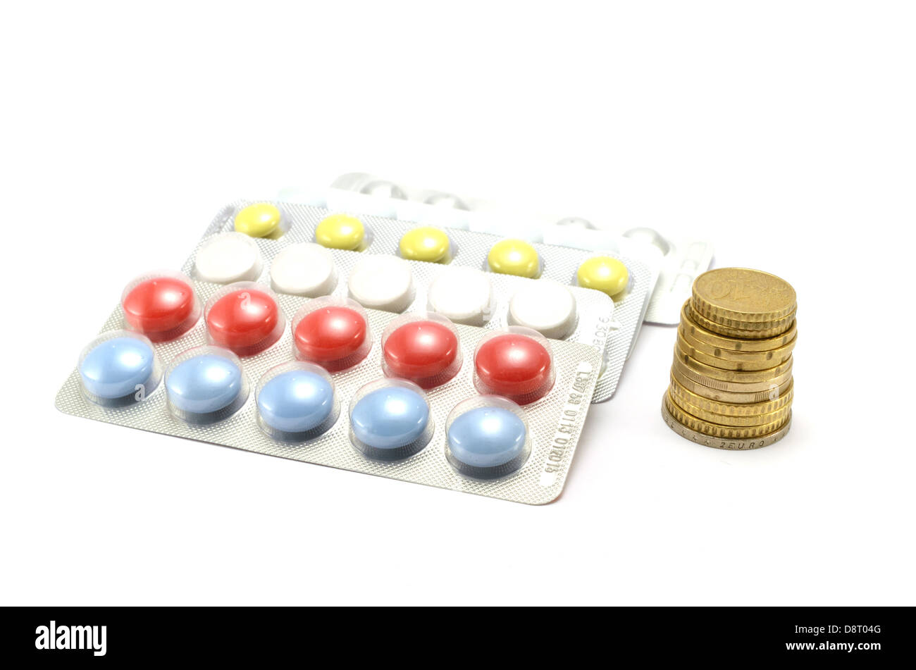tablets and coins on white background Stock Photo - Alamy