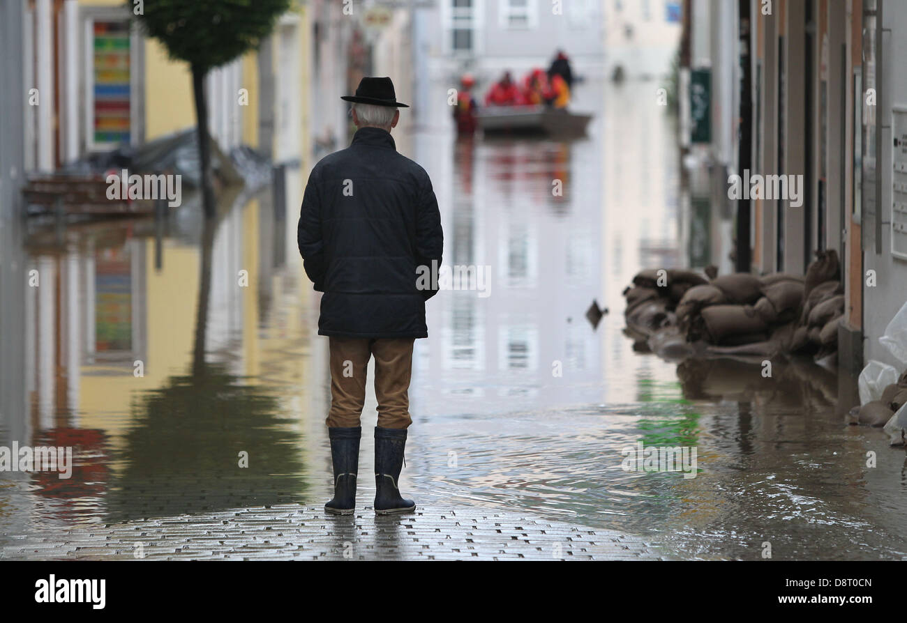 Passau, Germany. 4th June 2013. A passer-by stands in the flooded city ...