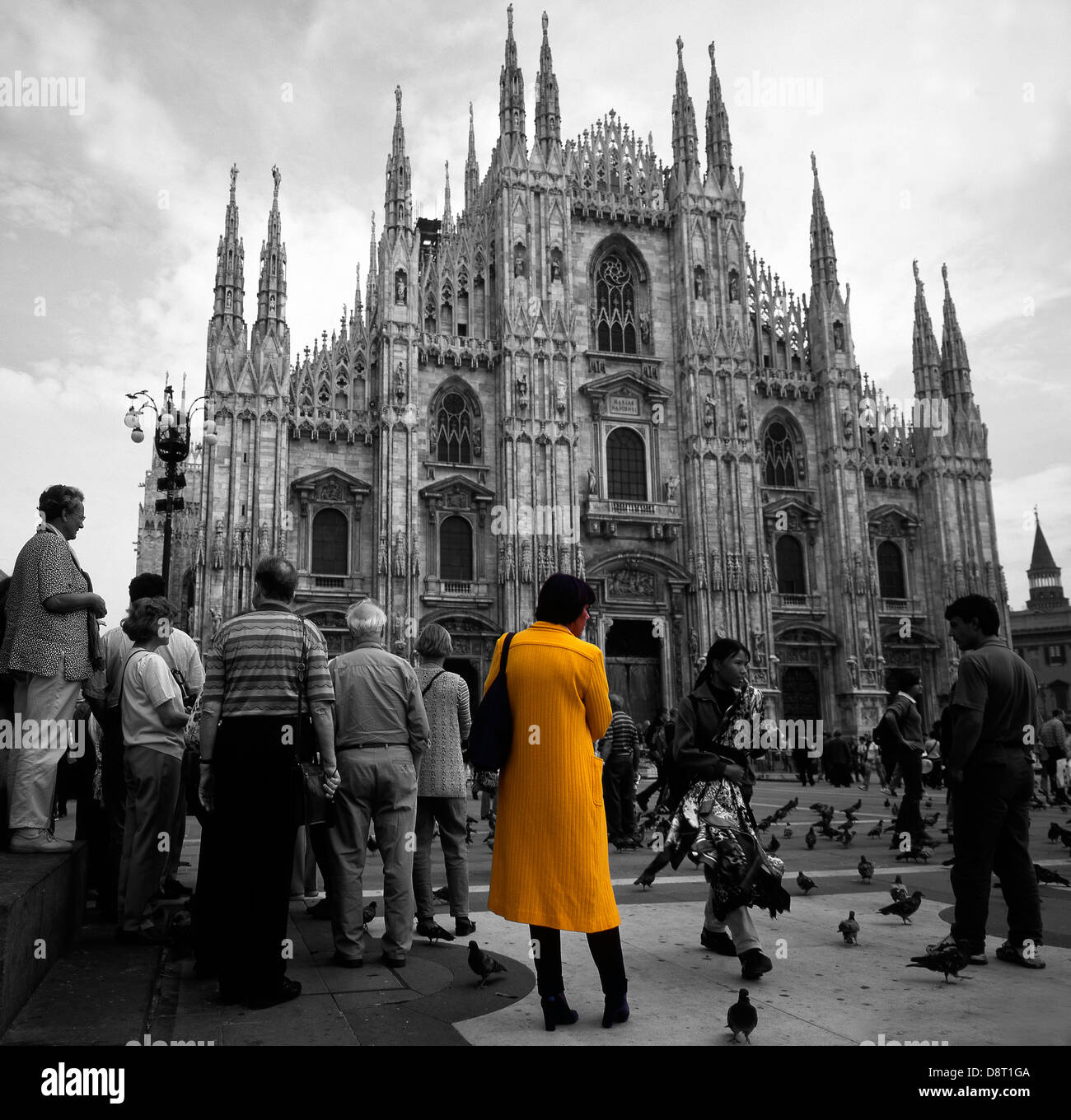 A crowd outside Duomo di Milano (Milan cathedral), Italy, with a woman ...