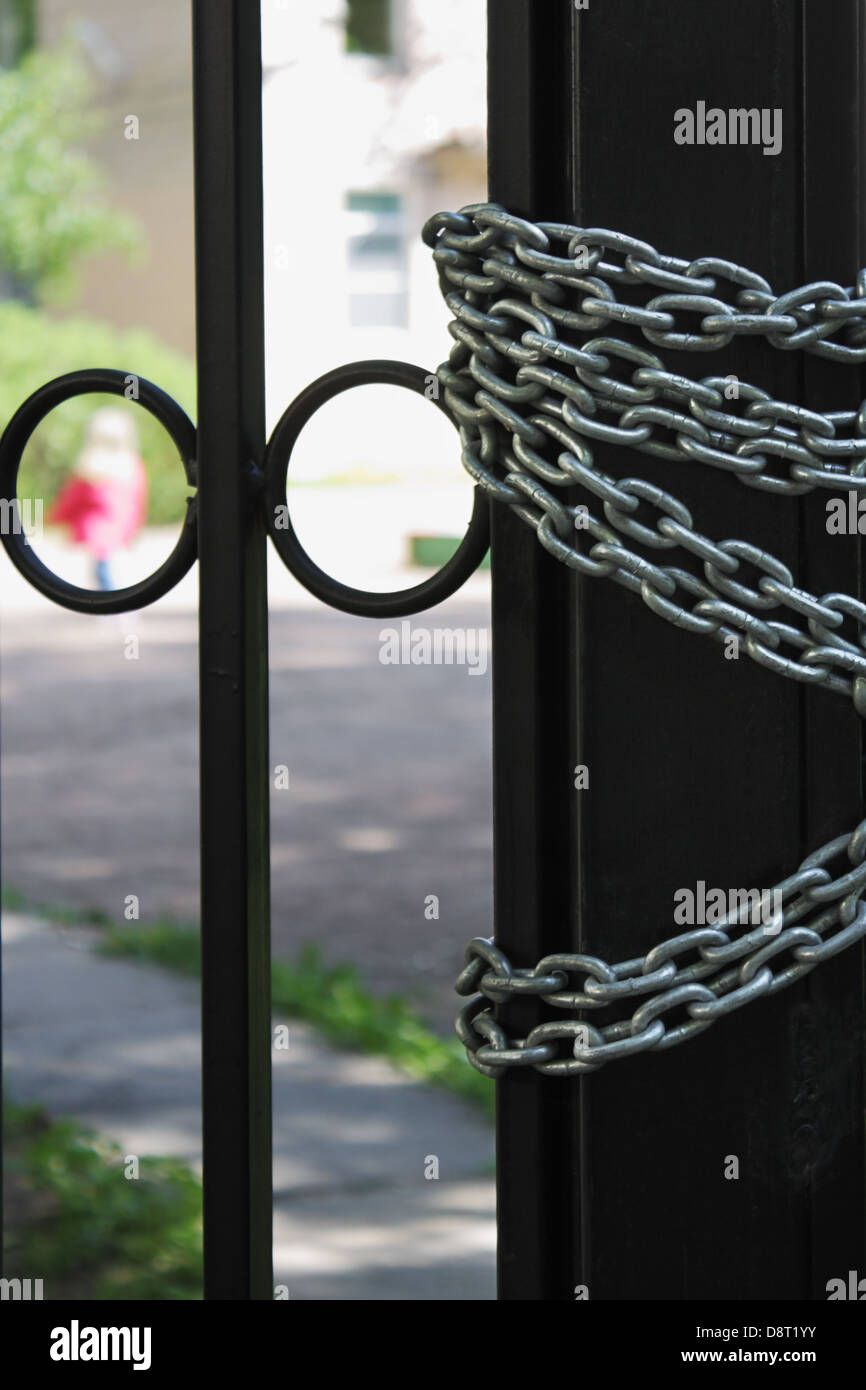 Chain on a metallic gate of a kindergarten Stock Photo - Alamy