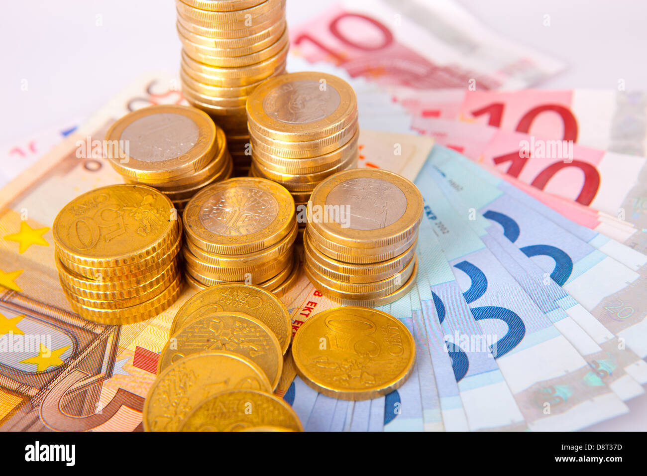 Pile of notes and coins Stock Photo - Alamy