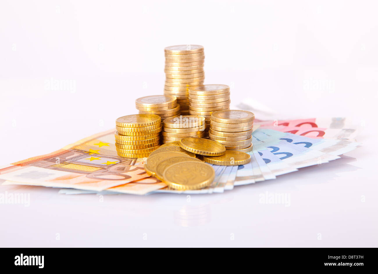 Pile of notes and coins Stock Photo - Alamy