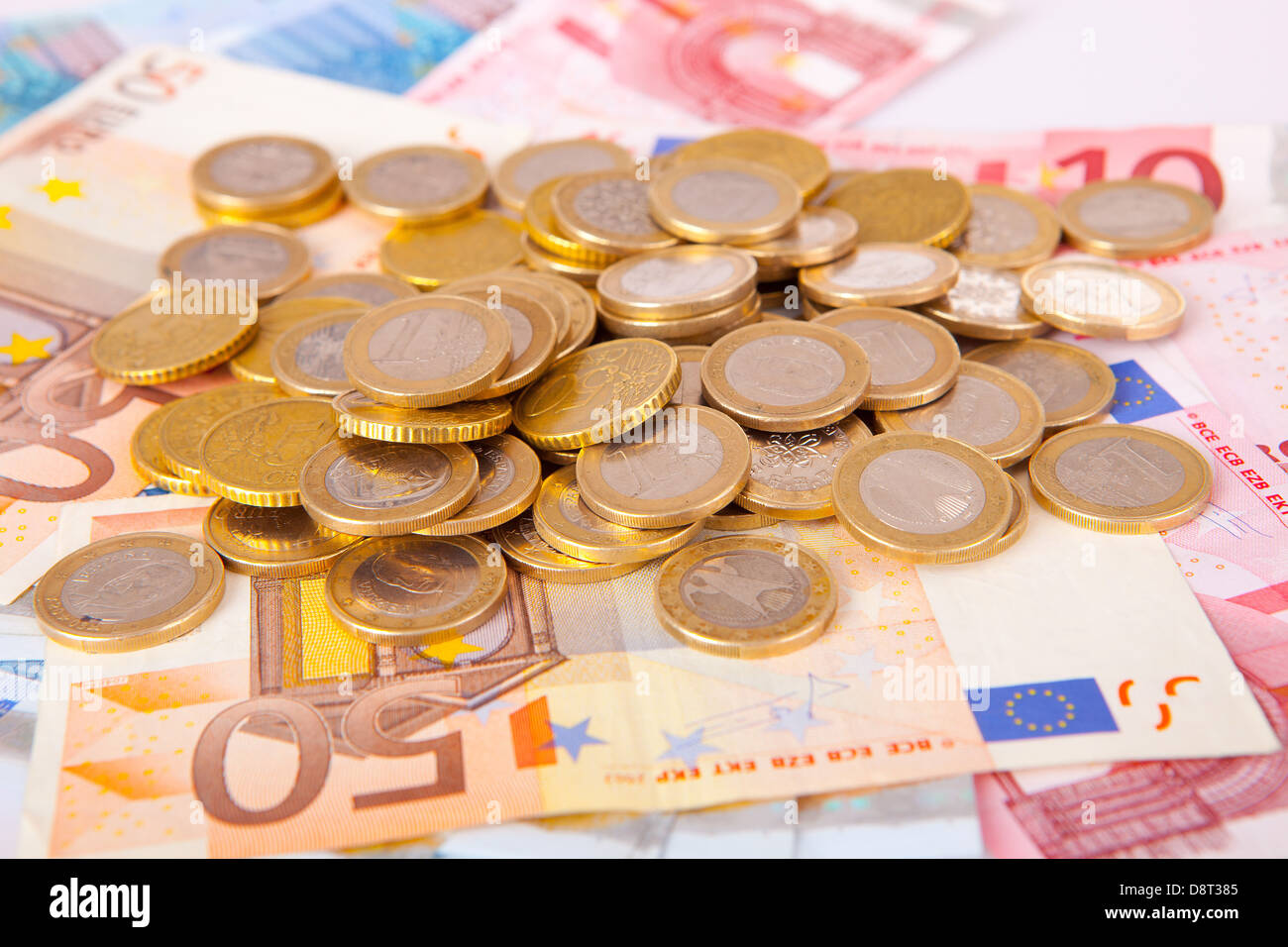 Pile of notes and coins Stock Photo - Alamy