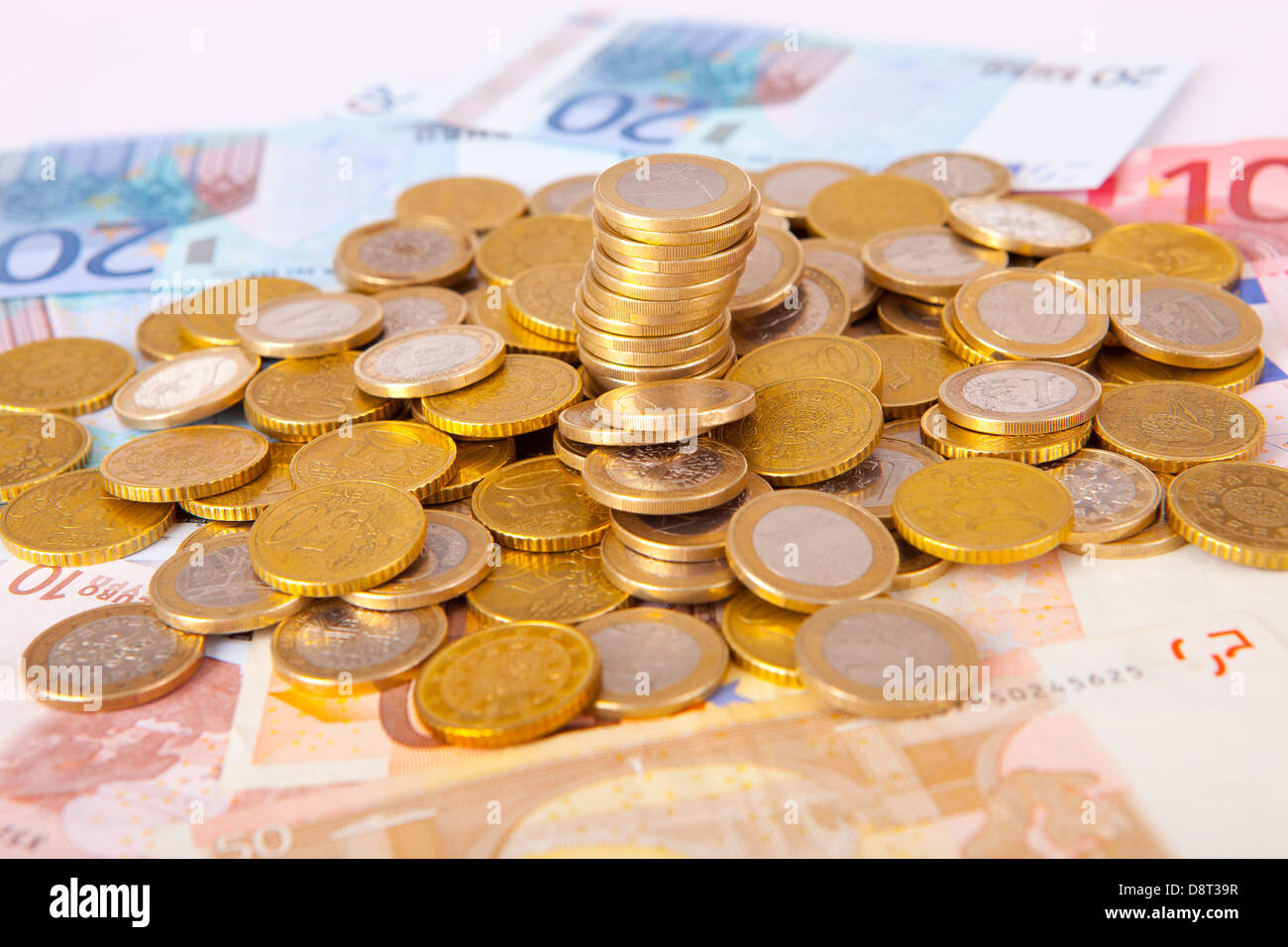 Pile of notes and coins Stock Photo - Alamy