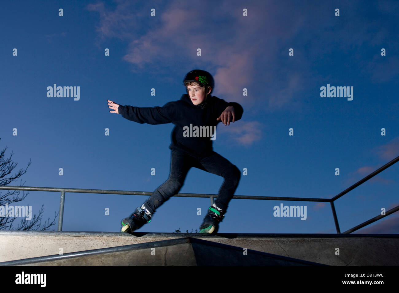Young Inline skater sliding along a rail at a Fife Skate Park Stock ...