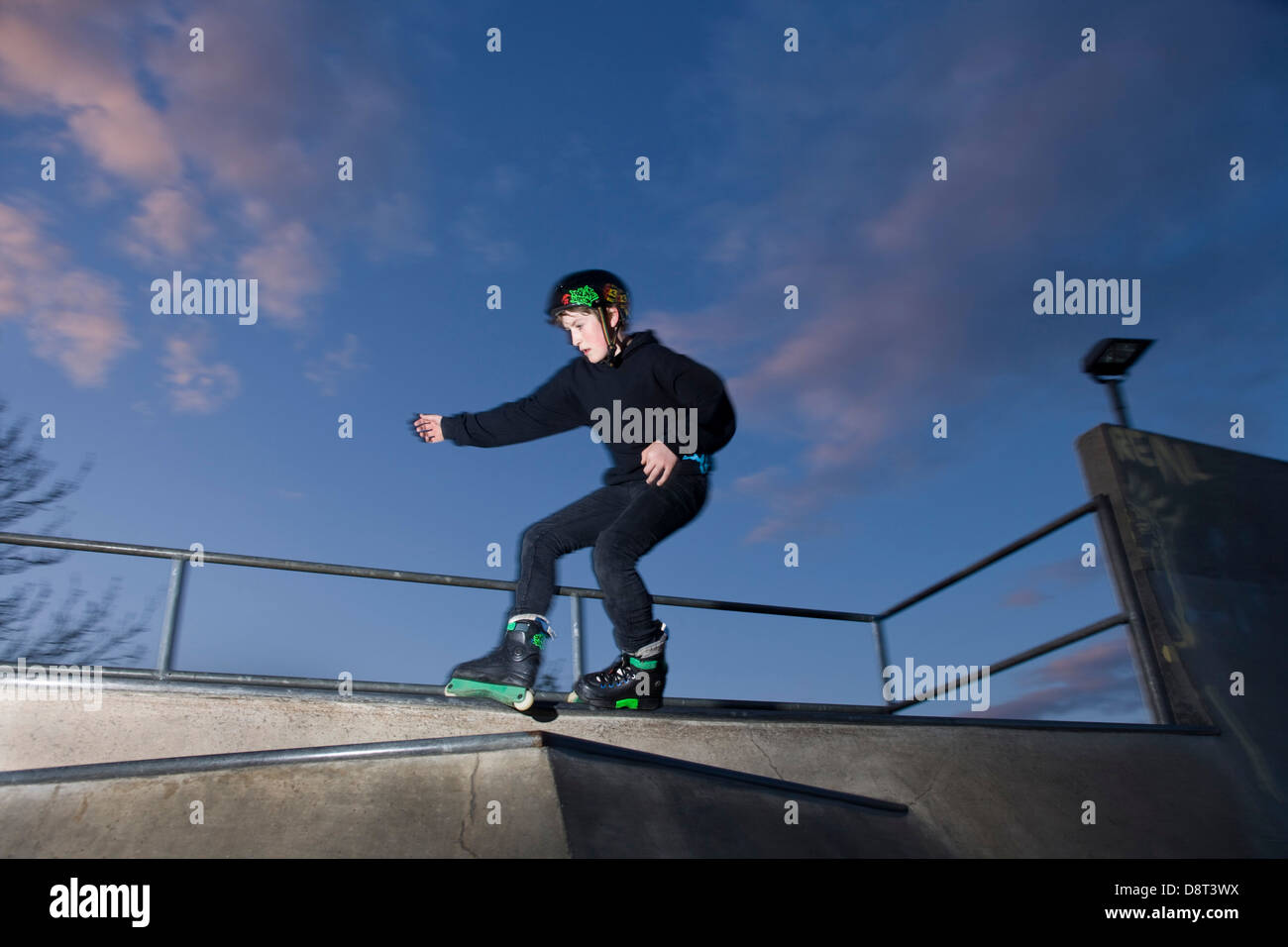 Young Inline skater sliding along a rail at a Fife Skate Park Stock ...