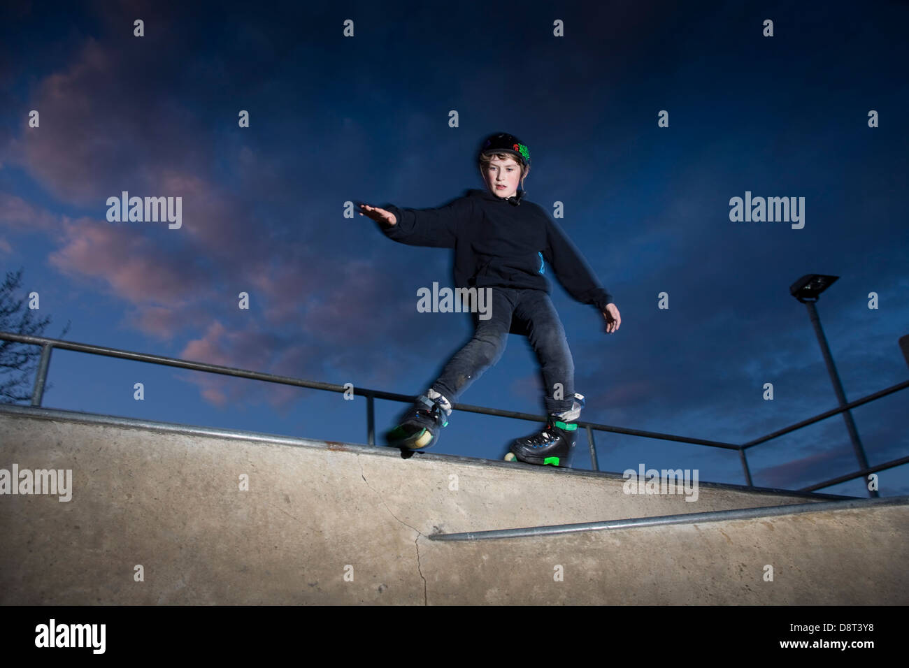 Young Inline skater sliding along a rail at a Fife Skate Park Stock ...
