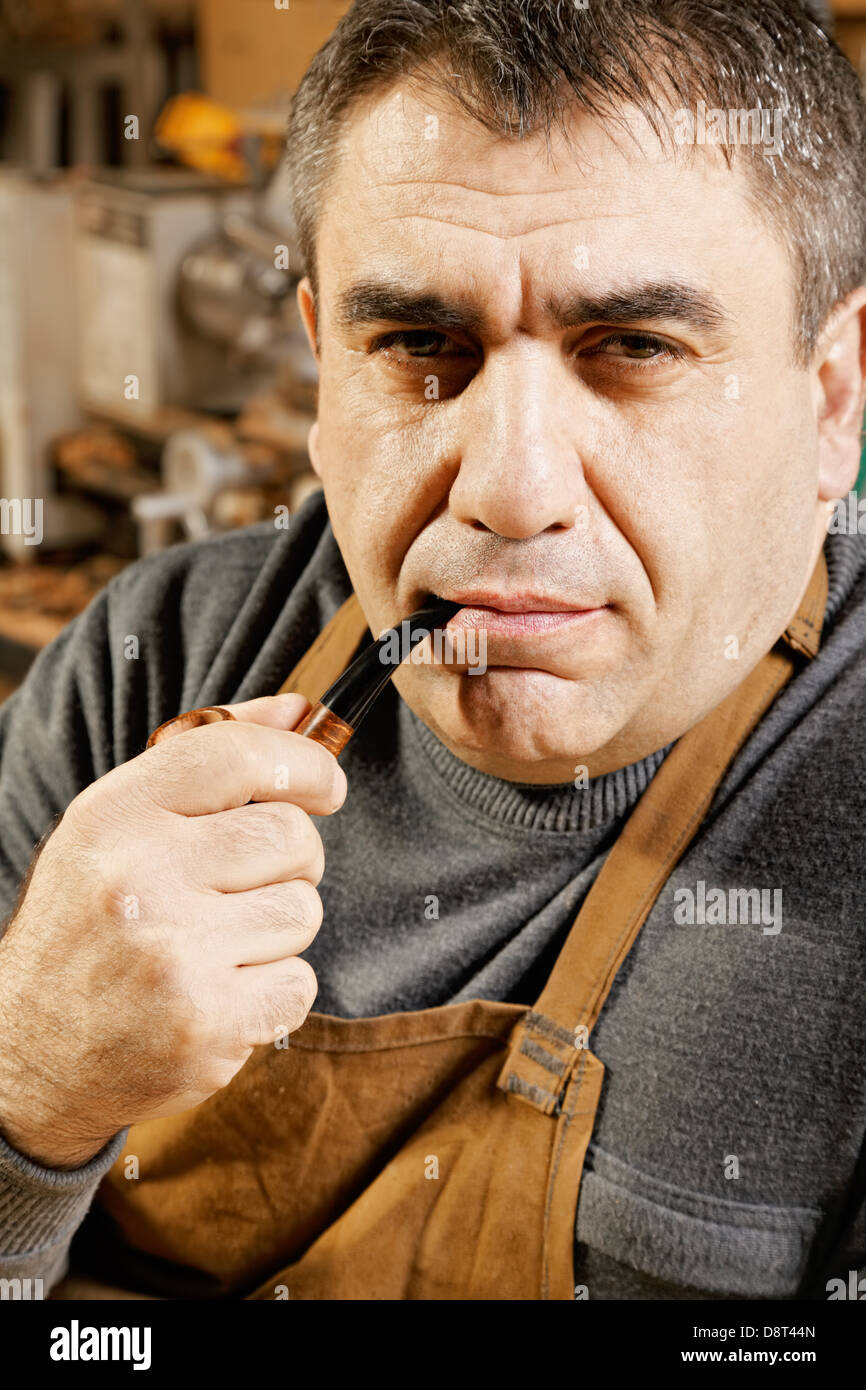 Serious guy smoking pipe Stock Photo - Alamy