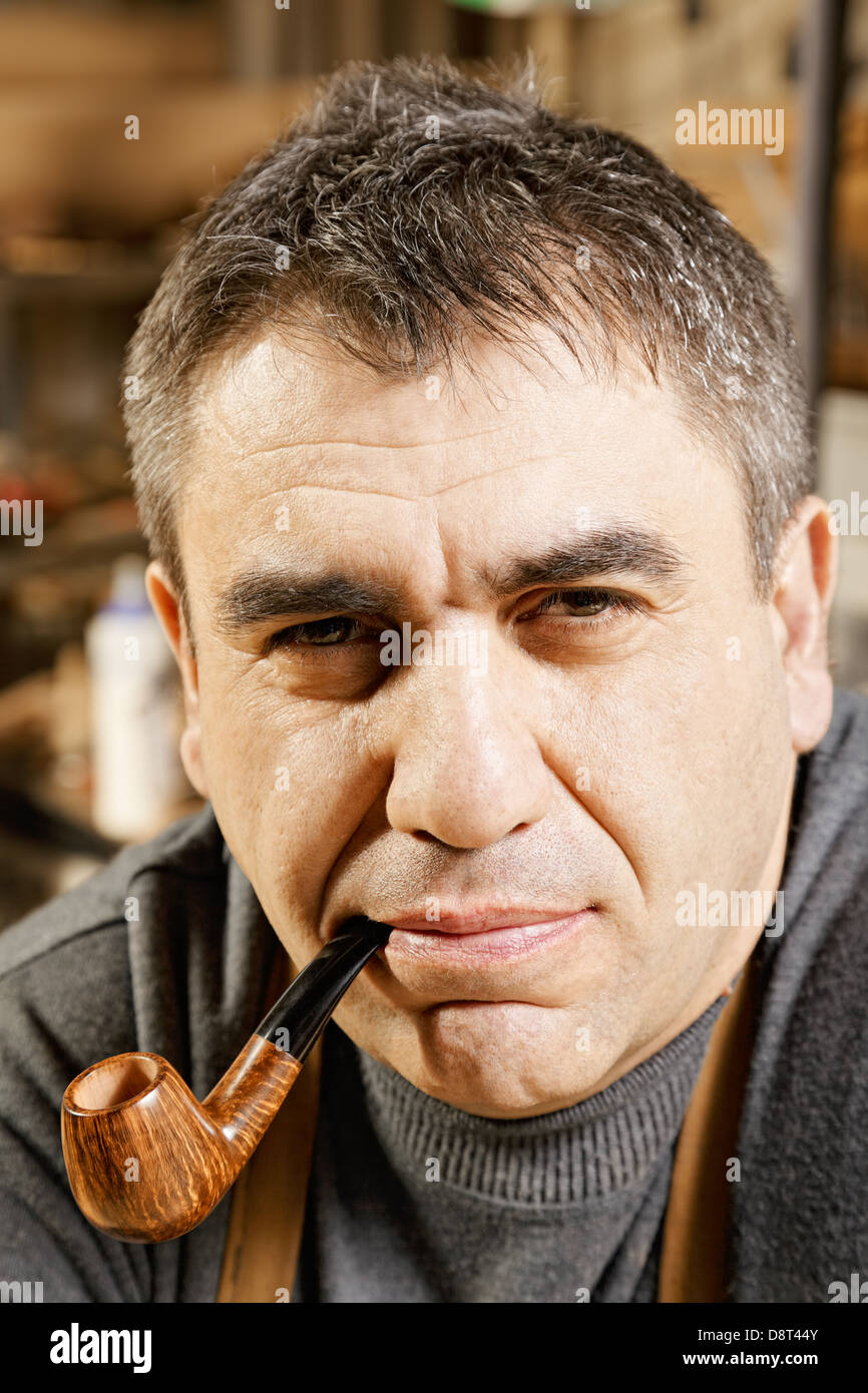 Caucasian guy smoking pipe Stock Photo - Alamy