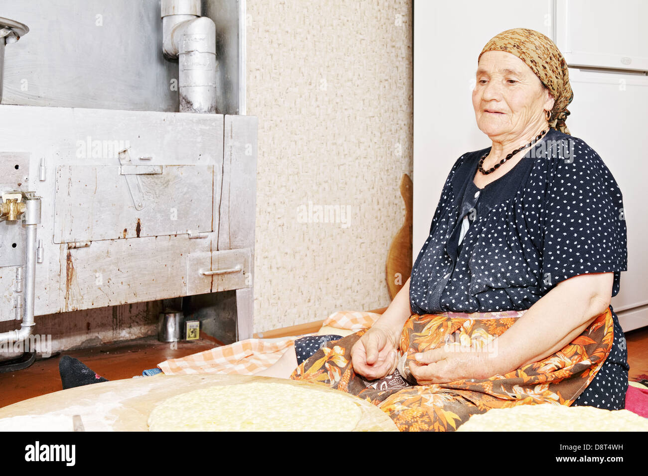 Pensive woman baking bread Stock Photo - Alamy