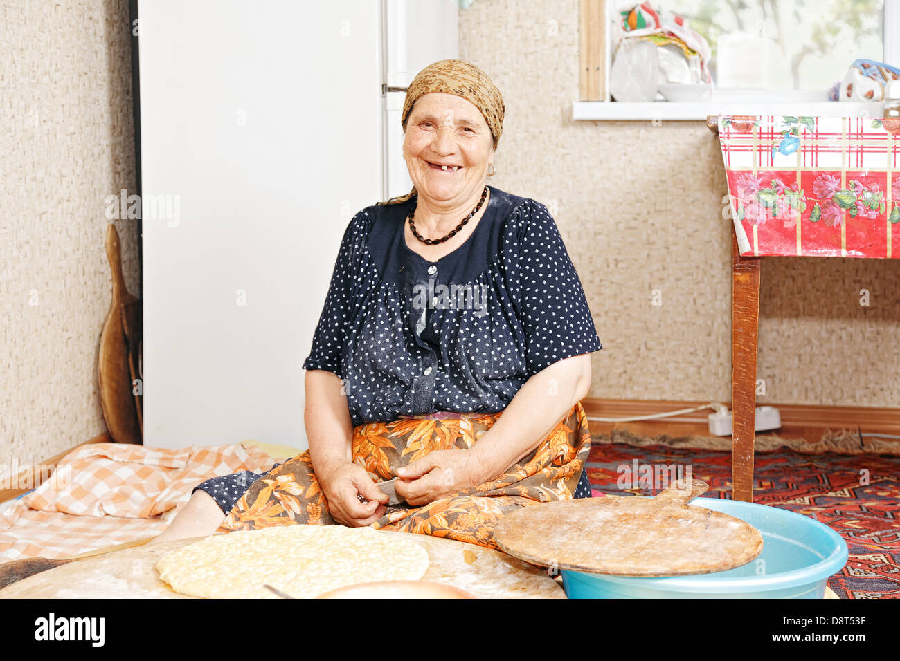 Happy woman baking bread Stock Photo - Alamy