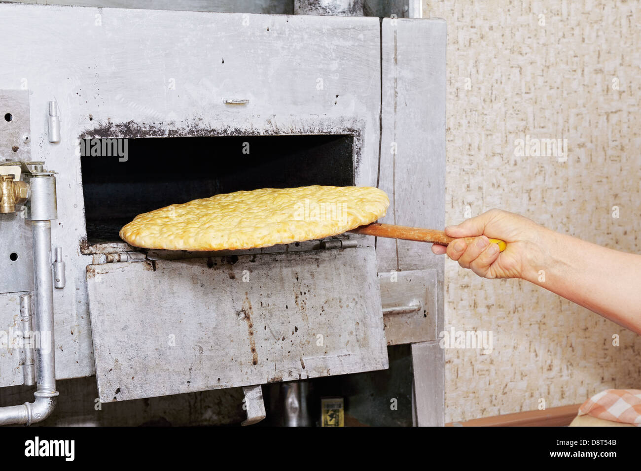 Hand takes prepared bread from oven Stock Photo - Alamy