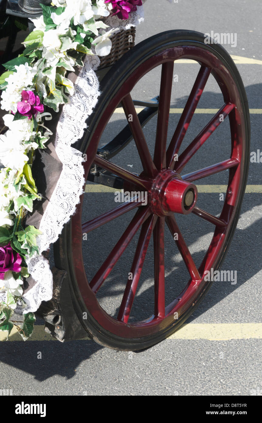 wedding carriage close up of details of ribbons and flowers on wheel ...