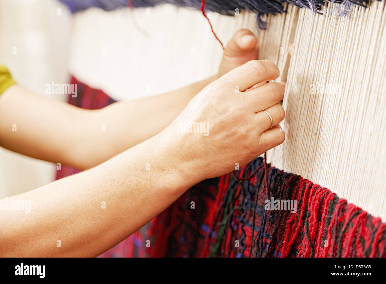 Woman hands weaving carpet Stock Photo - Alamy