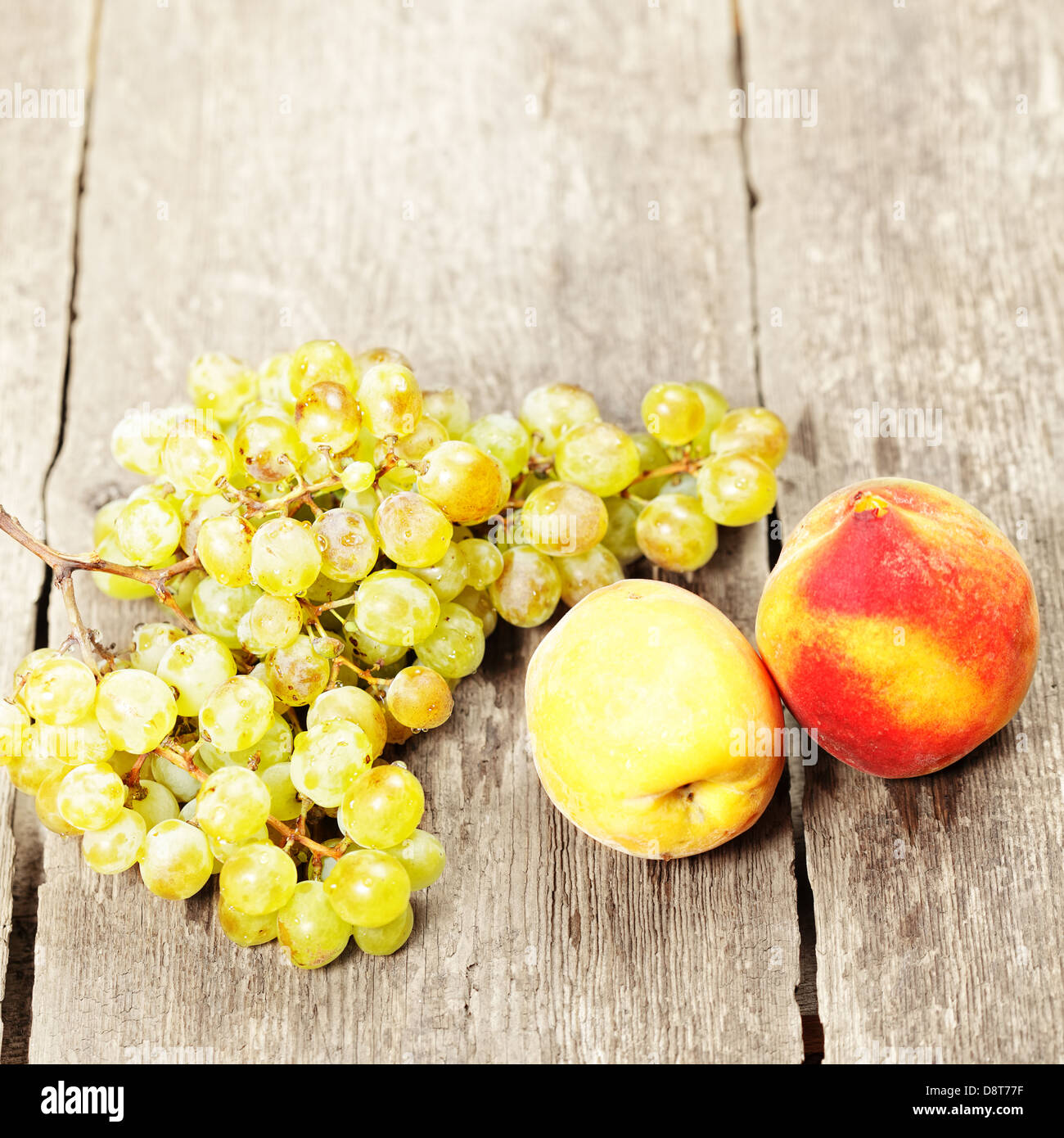 Two peaches and grape Stock Photo - Alamy