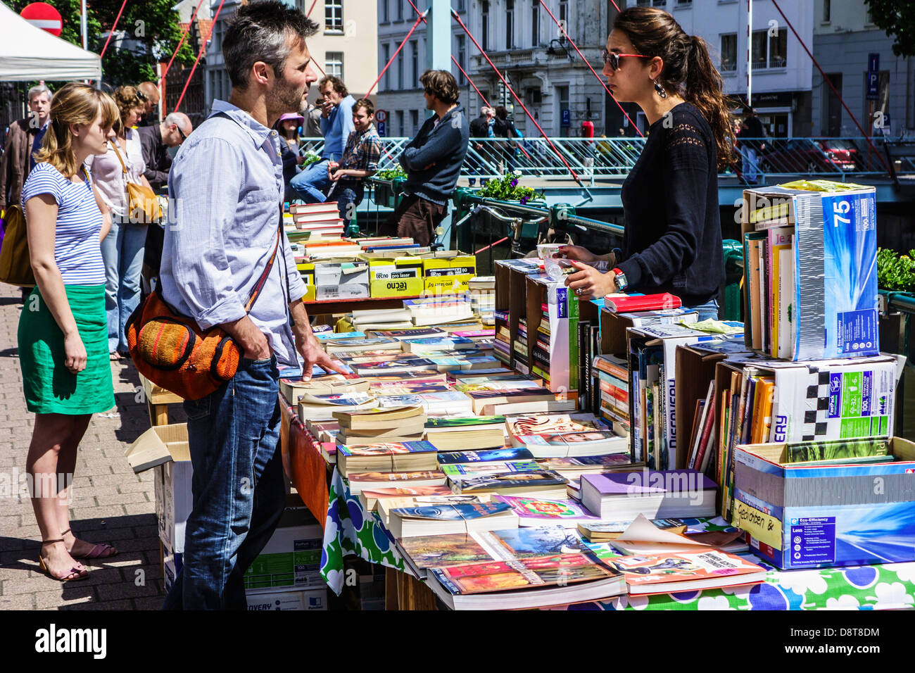 Man buying secondhand used books from stallholder at the Ajuinlei book ...