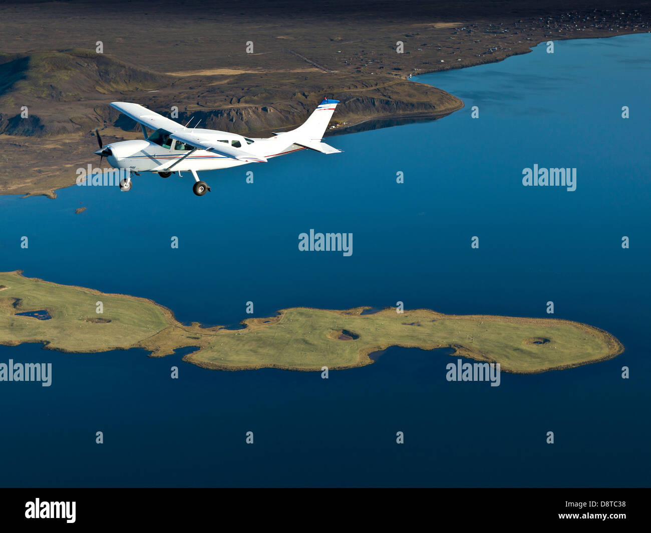 Cessna flying over South Coast in Iceland Stock Photo - Alamy