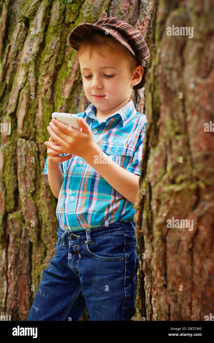 Young boy reading sms on his phone Stock Photo - Alamy