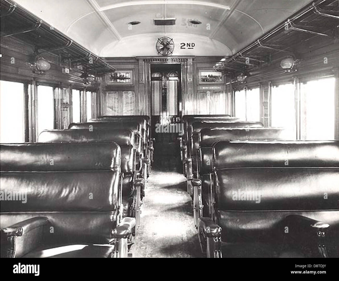 A black and white historical photograph of a 2nd class railway carriage ...