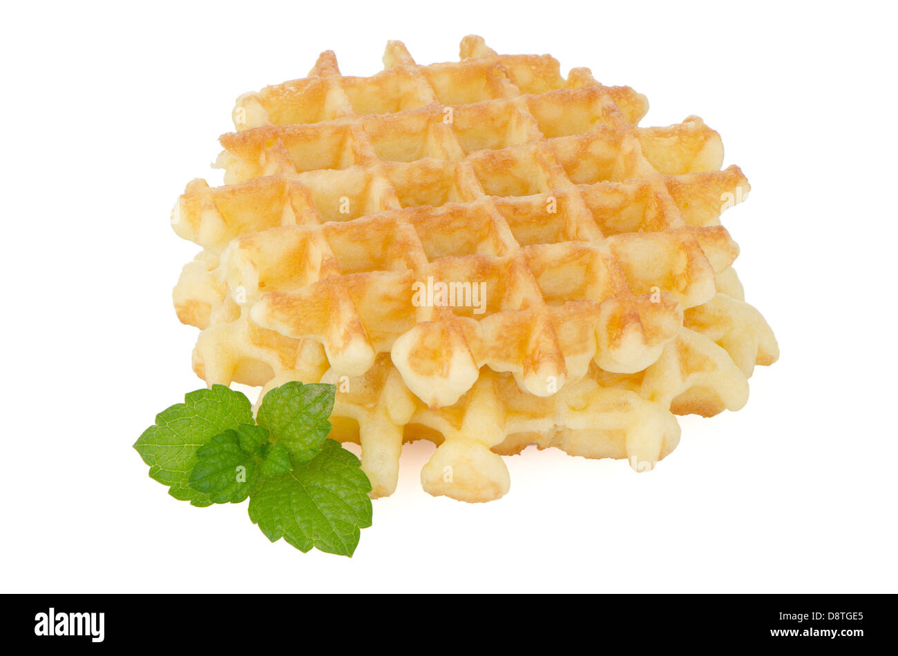 Pile of sweet waffles with green mint leaves isolated on white ...