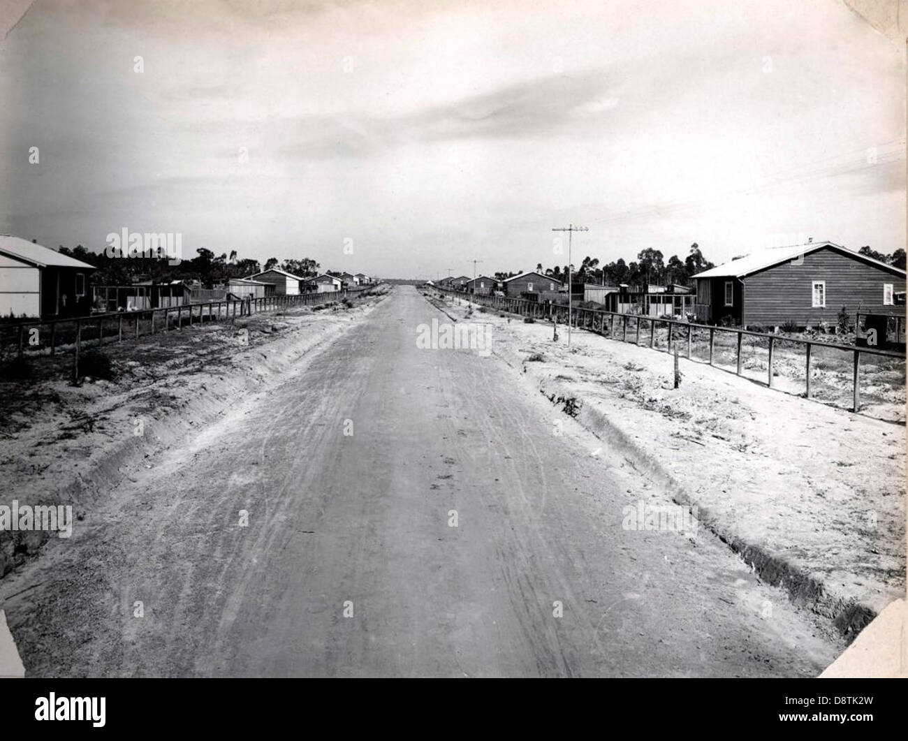 This black-and-white photograph captures early settlers' cottages in ...
