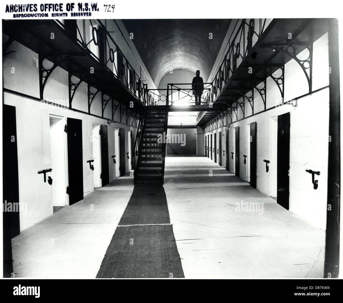 A black-and-white photograph from 1884 depicts the interior of a gaol ...