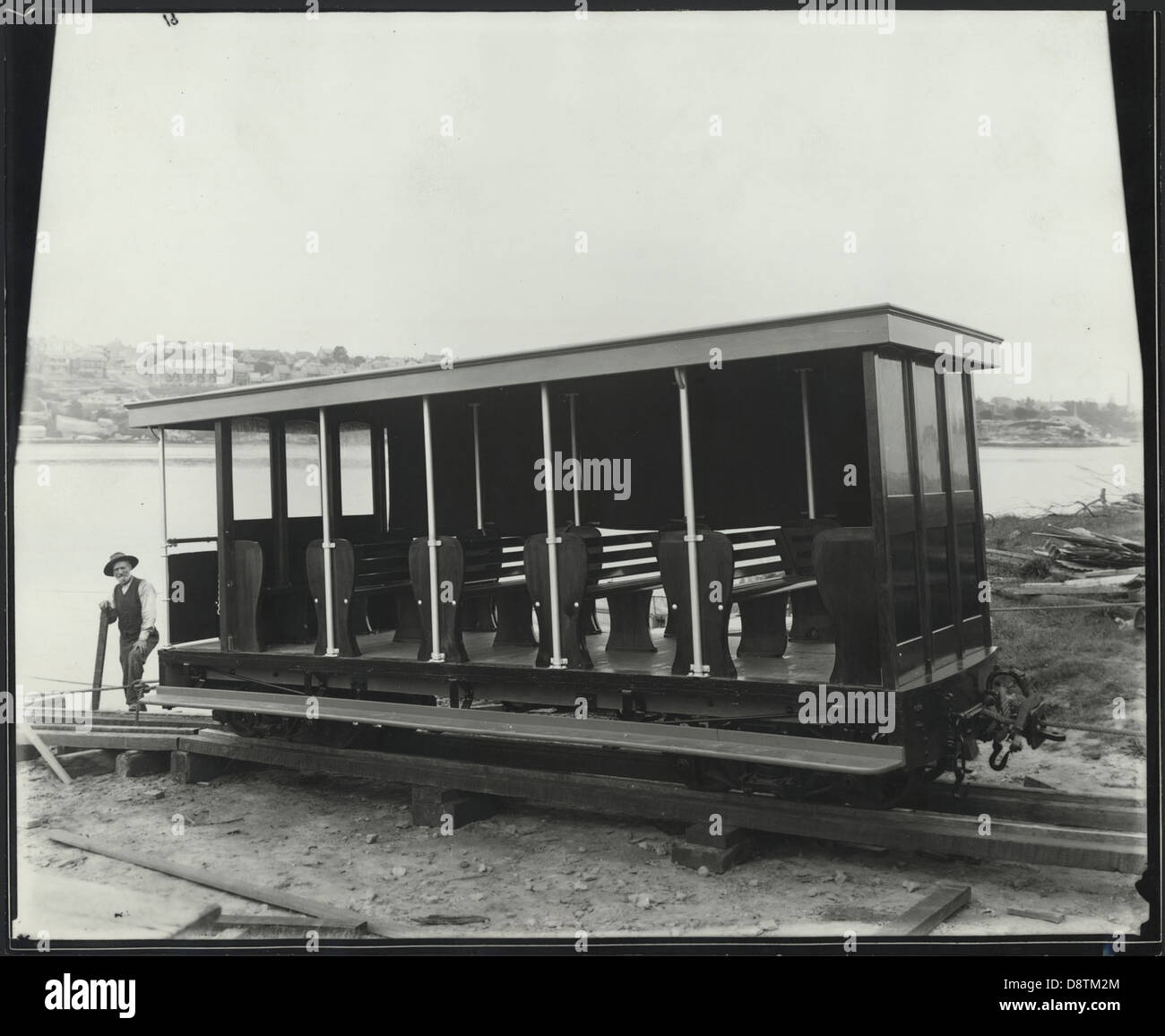 This black-and-white photograph showcases a cable tram trailer used in ...