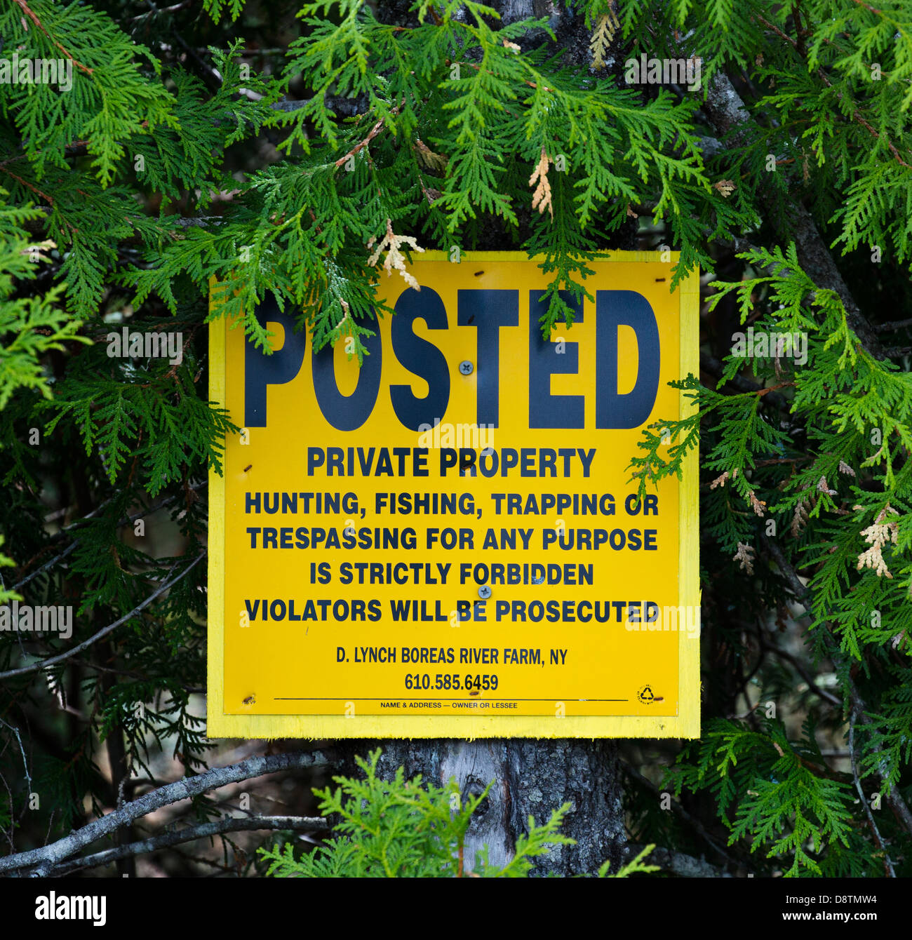 Posted private property yellow sign Stock Photo - Alamy