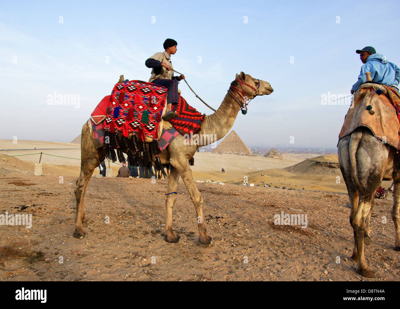 Two young Egyptian camel riders on the Giza Necropolis on the outskirts ...