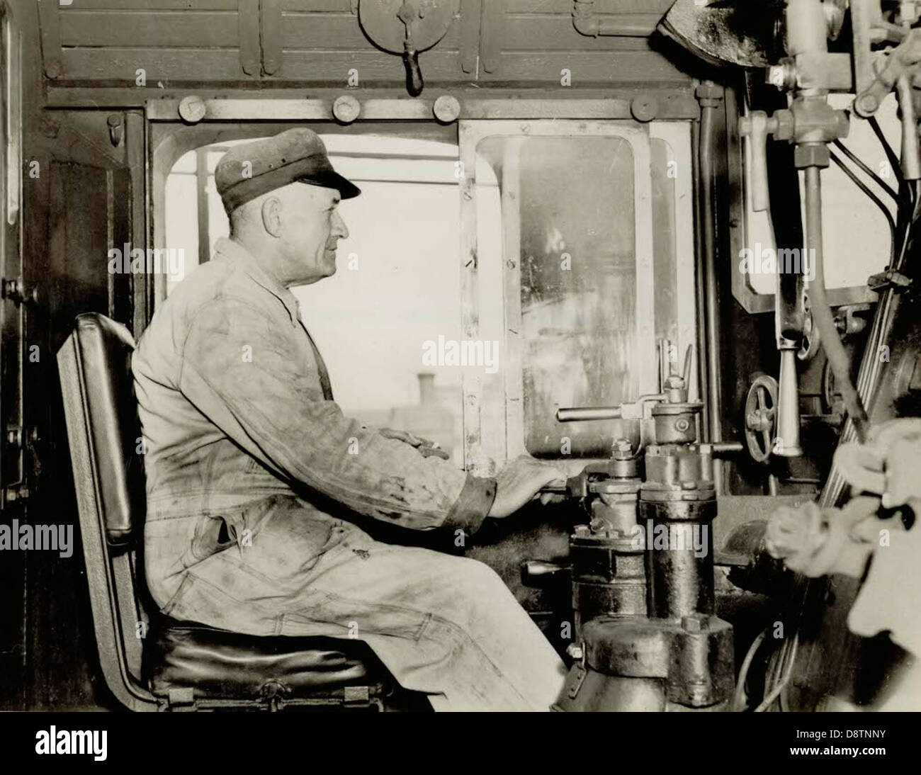 A black-and-white photograph from 1948 depicting a train driver ...