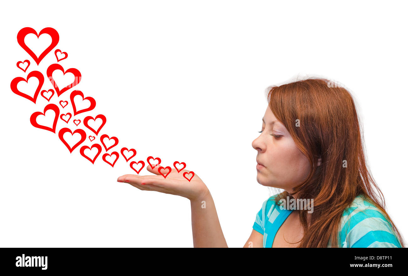 Young woman blowing hearts Stock Photo - Alamy