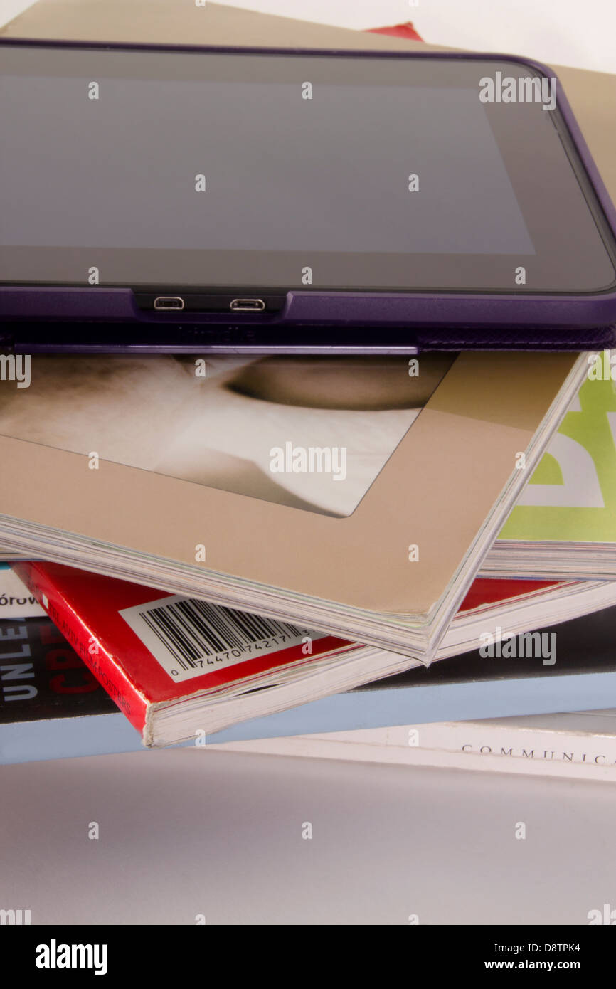 kindle sitting atop a stack of magazines on a white background Stock ...