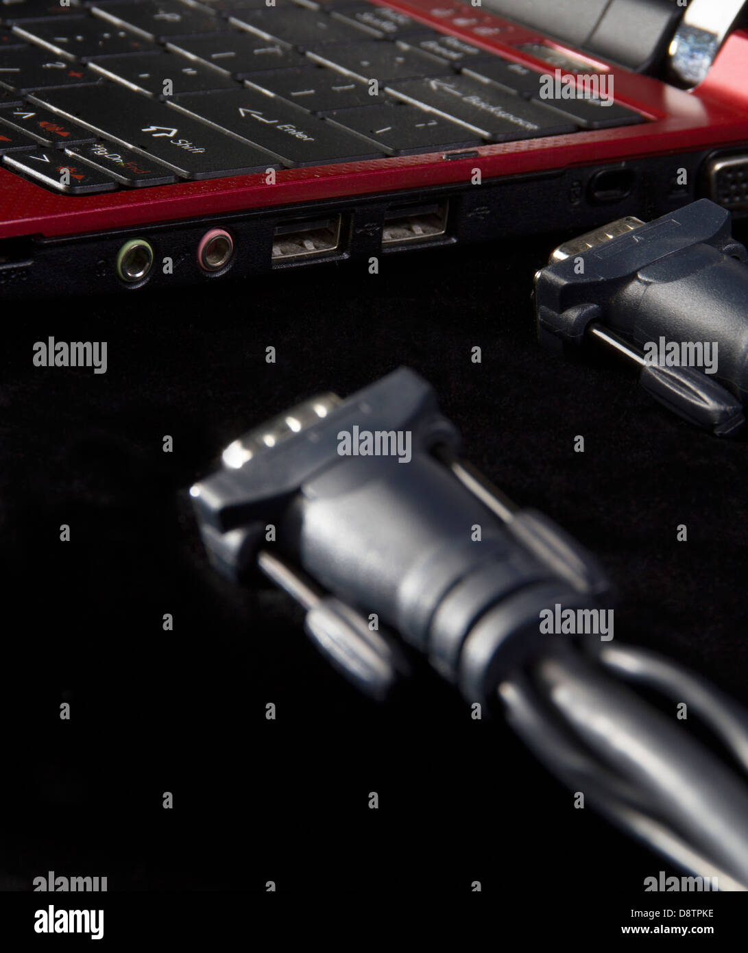 laptop computer and cables on black background Stock Photo - Alamy