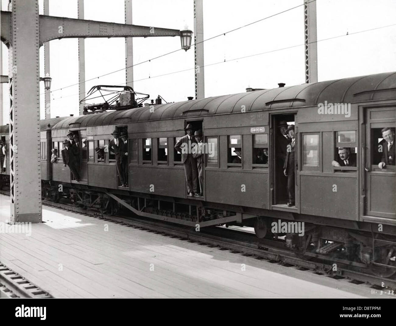 This black-and-white photograph captures the first electric train ...