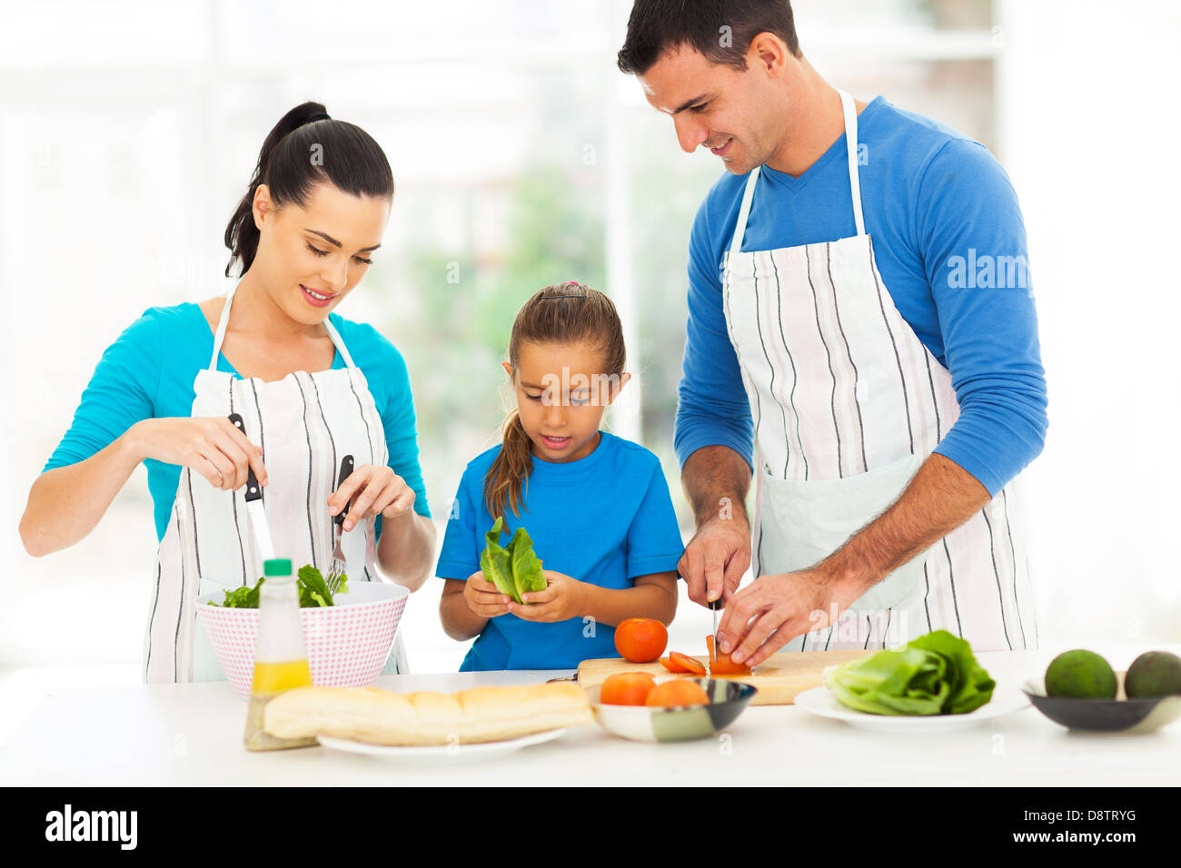 lovely young family preparing food in kitchen at home Stock Photo - Alamy