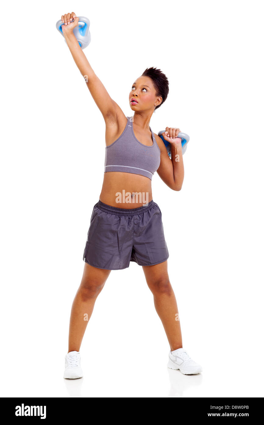 beautiful african woman lifting kettle bell over white background Stock ...