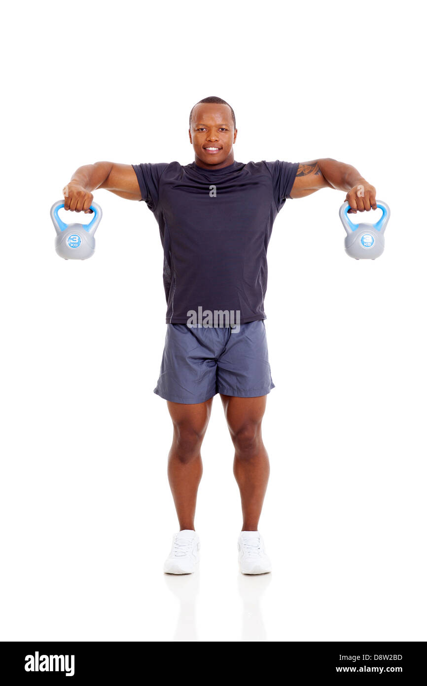 healthy african man doing workout with kettle bells on white background ...