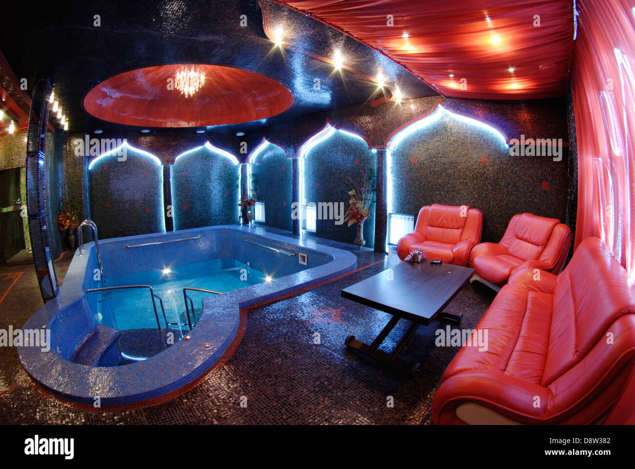 violet pool with red furniture Stock Photo - Alamy