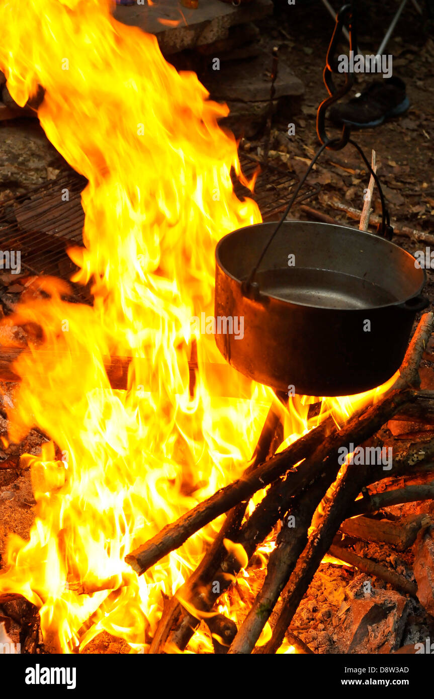 Cooking at night over campfire Stock Photo - Alamy
