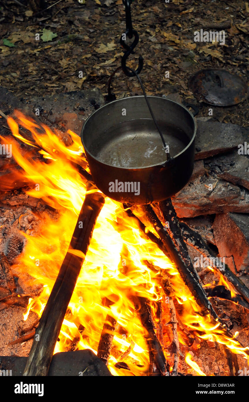 Cooking at night over campfire Stock Photo - Alamy