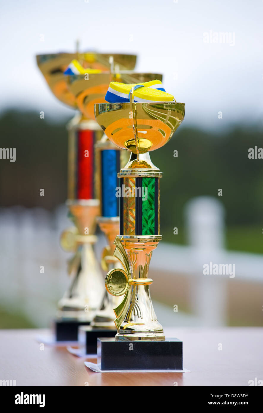 three prize cups in perspective Stock Photo - Alamy