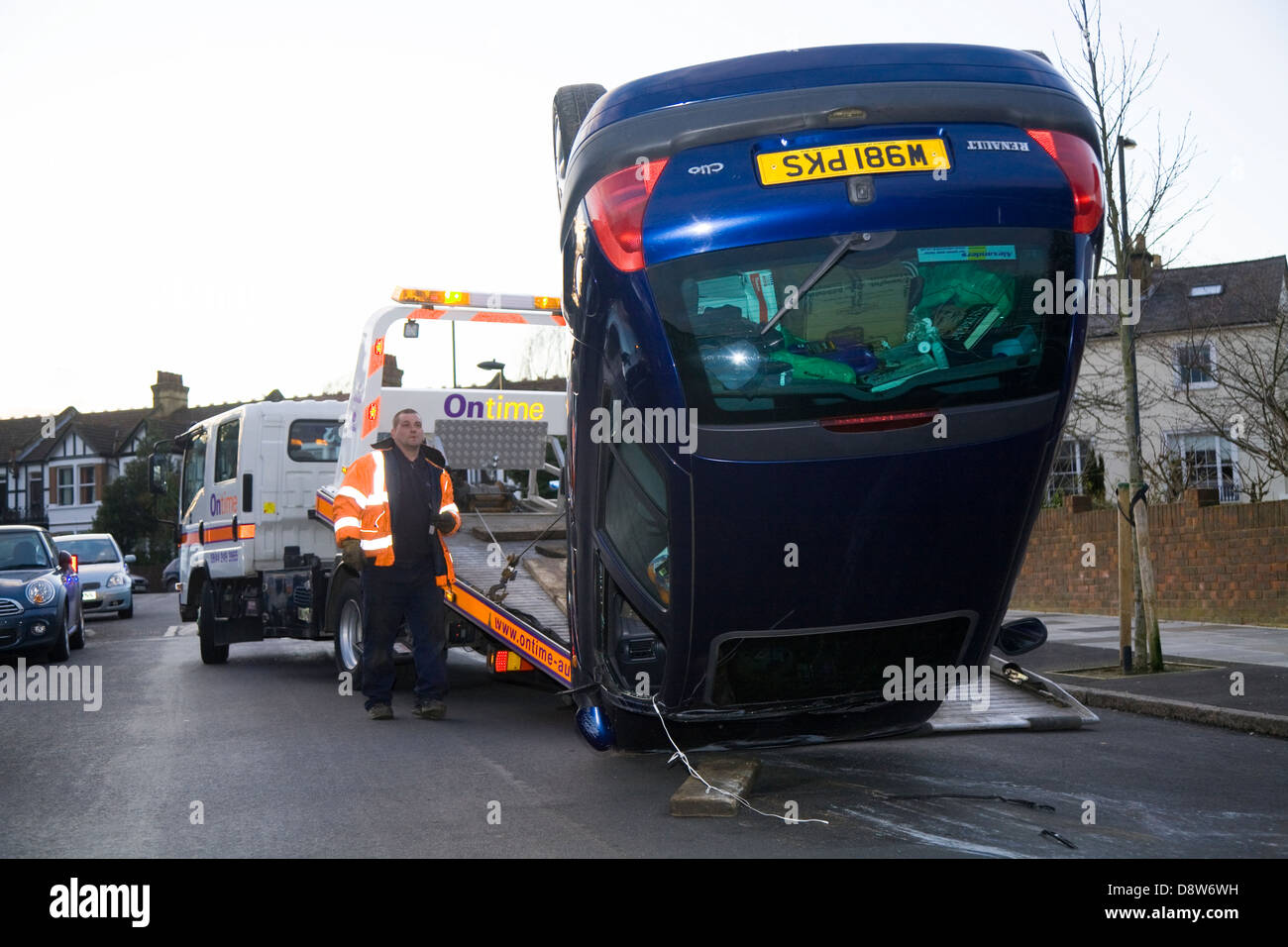 Car recovery vehicle man & tow truck removes upside down car which lost ...
