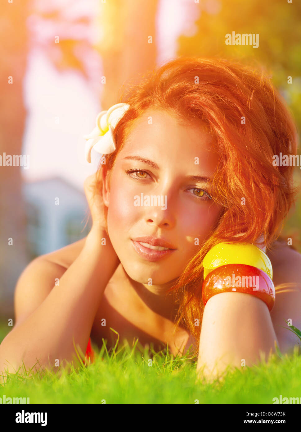 Closeup Portrait Of Pretty Girl With Fresh Frangipani Flower In Red