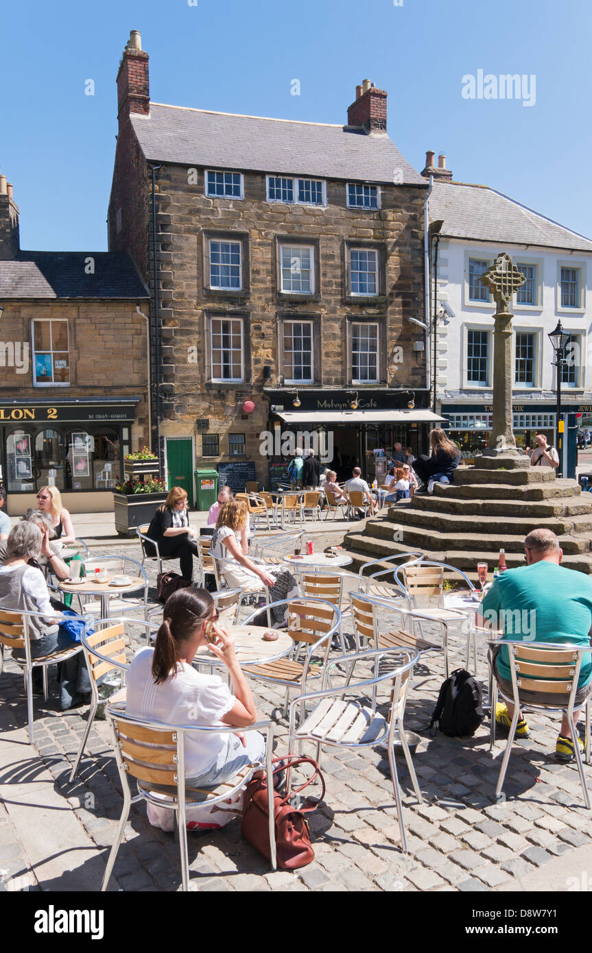 People sitting eating drinking within Alnwick market square ...