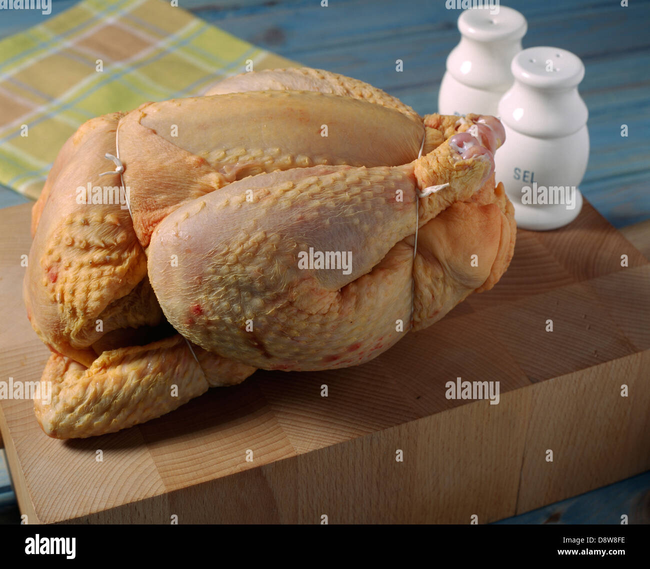 Preparing a chicken to be cooked Stock Photo - Alamy