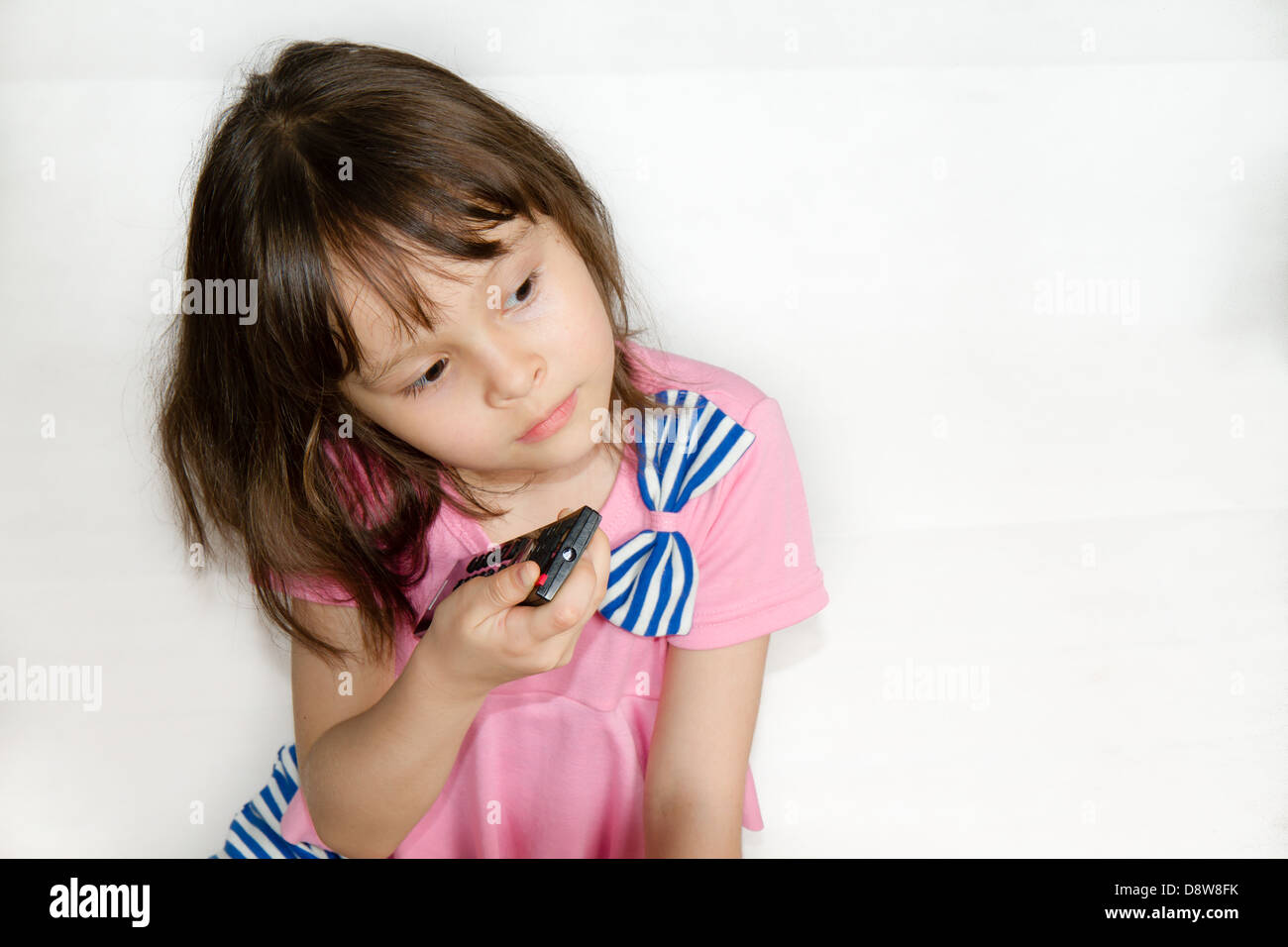 Asian child with remote control Stock Photo - Alamy