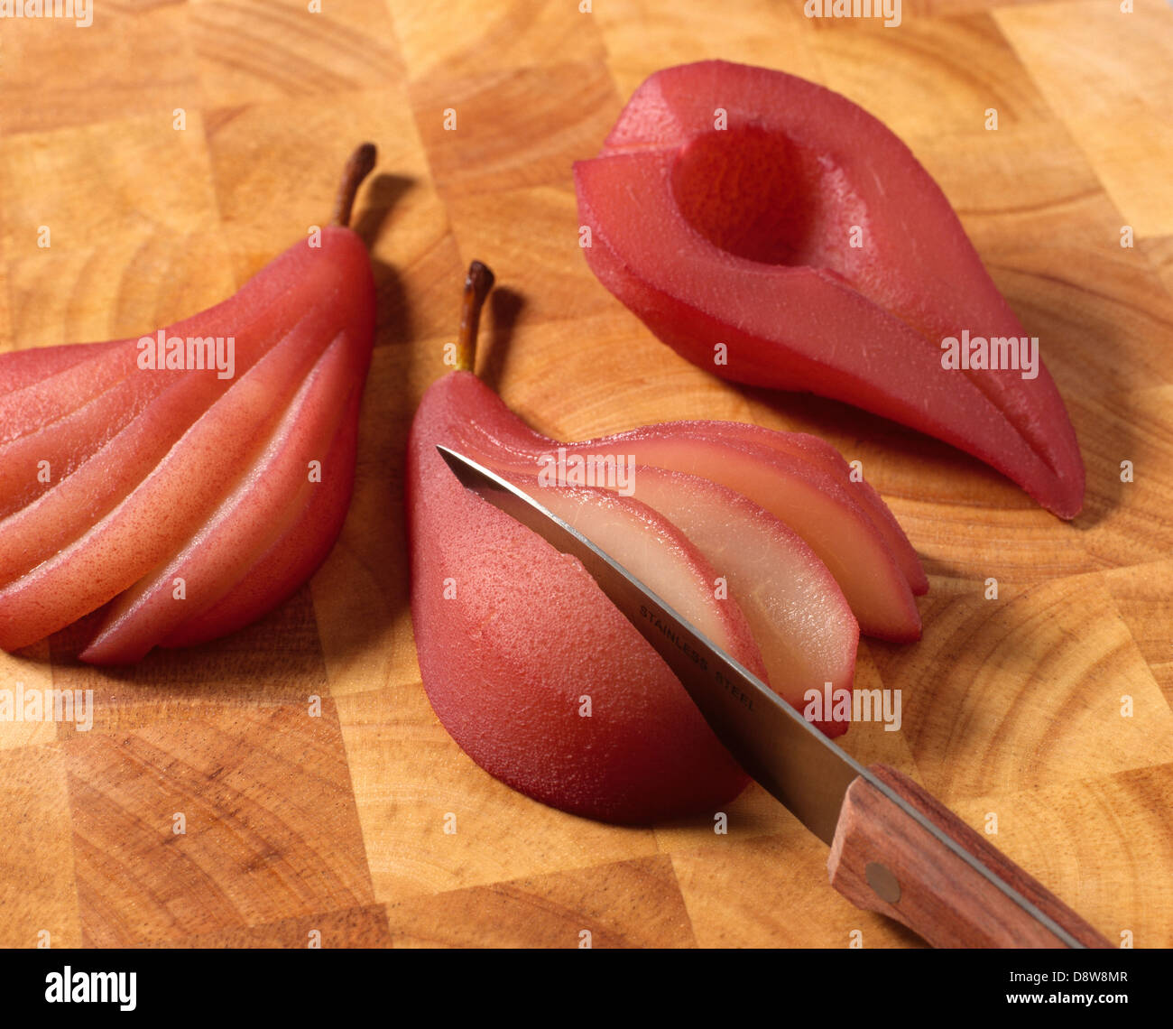 Slicing the halved pears Stock Photo - Alamy