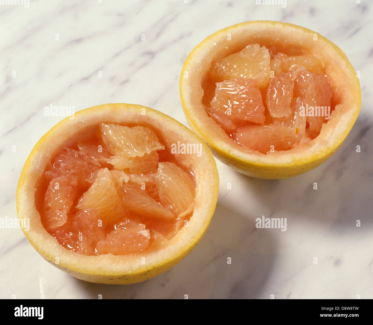 Refilling the grapefruit skins with the segments,sprinkle with sugar ...
