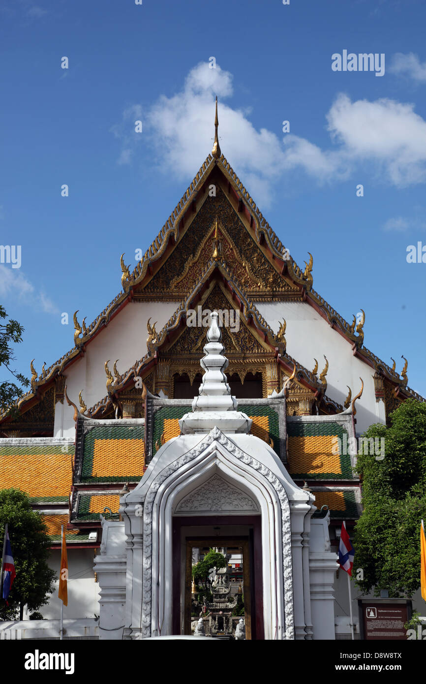 It's a photo of a Tall Buddhist gate near a temple. It's in red color ...